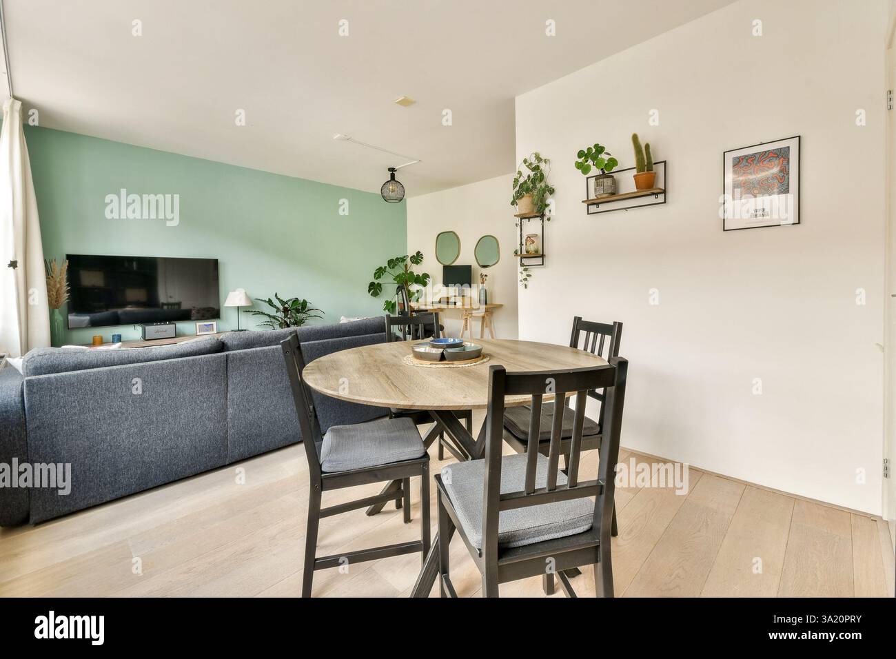 A contemporary living space featuring a cozy seating area, dining table ...