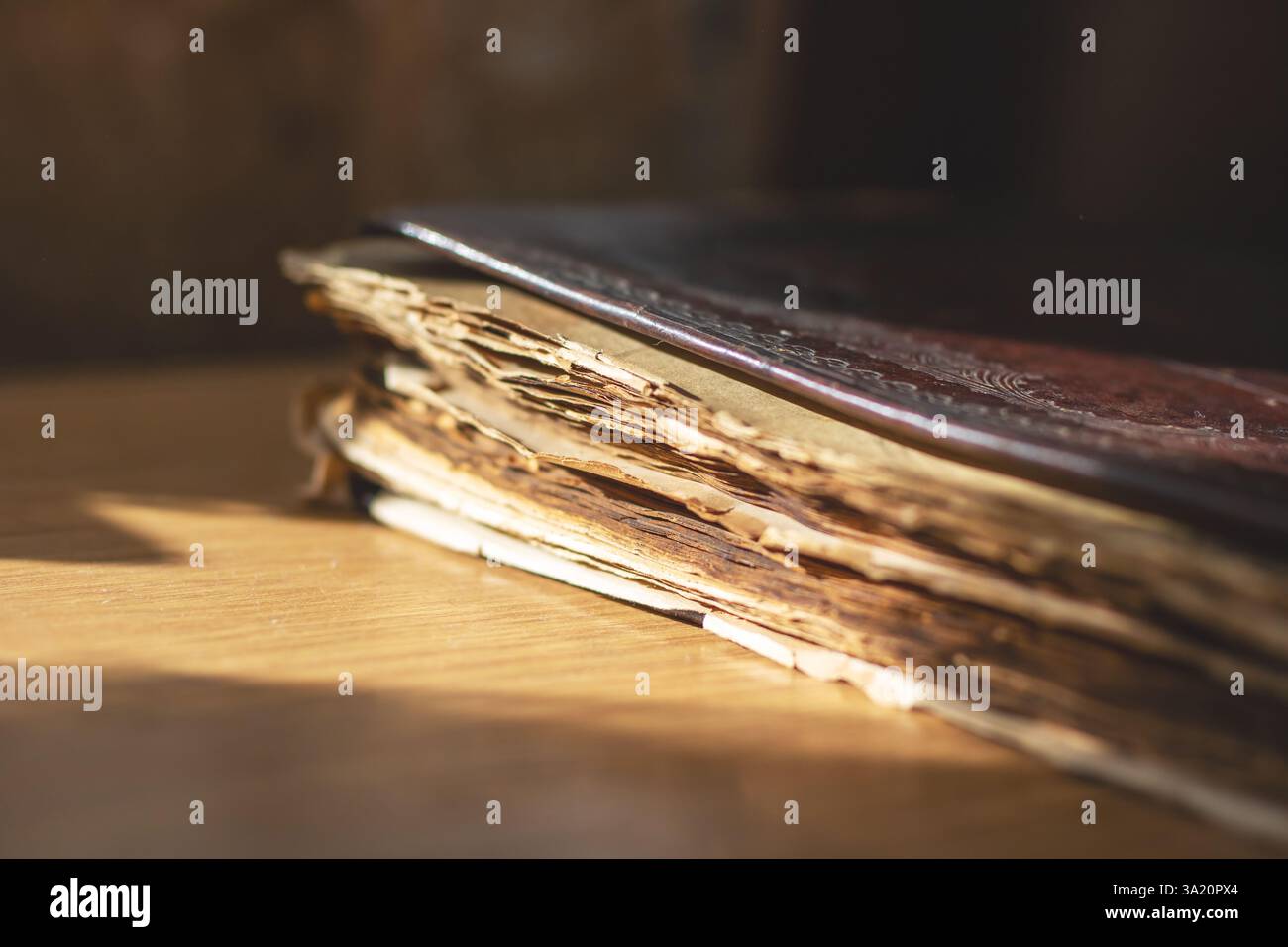 A stack of various old and vintage books is neatly arranged on a ...