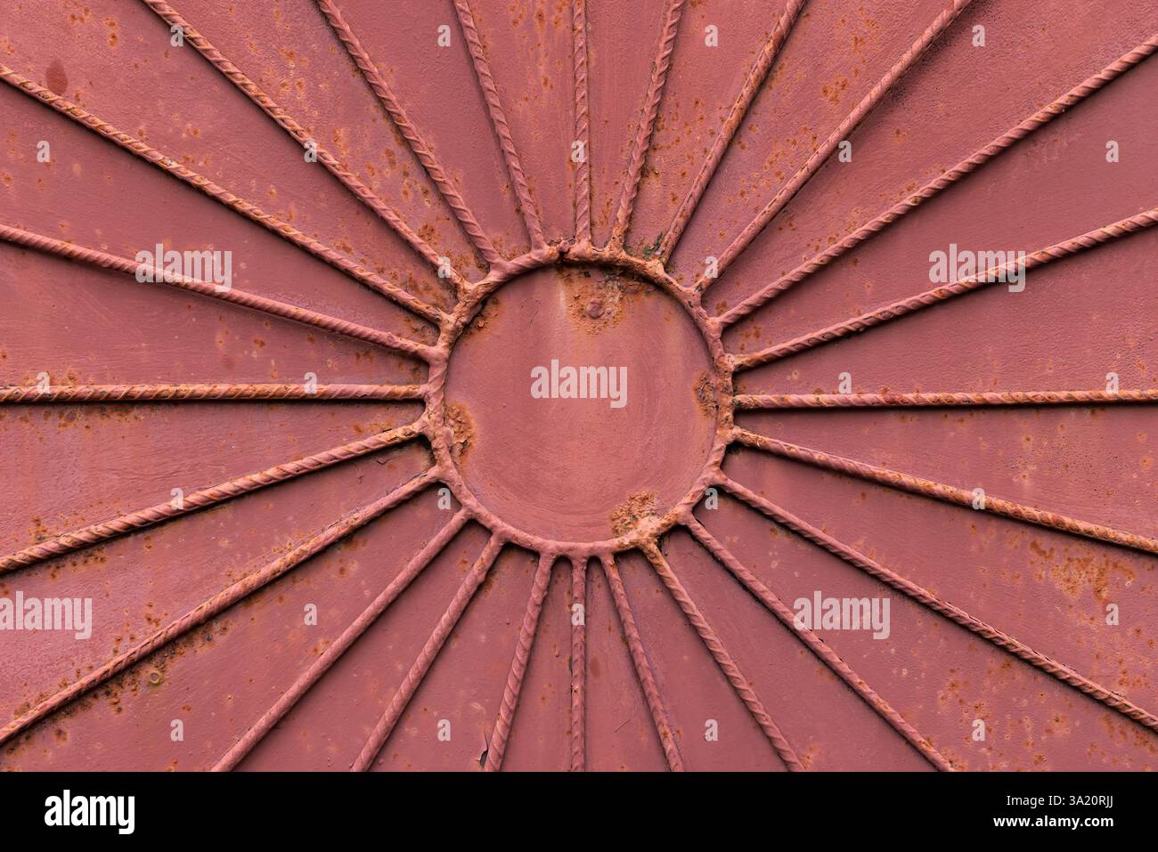 A detailed view of a radial metal design with rust texture, showing ...
