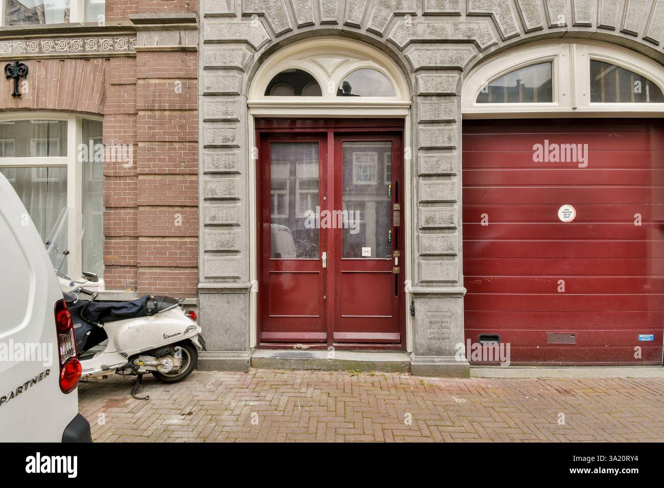 A striking red doorway framed by classic architecture showcases ...
