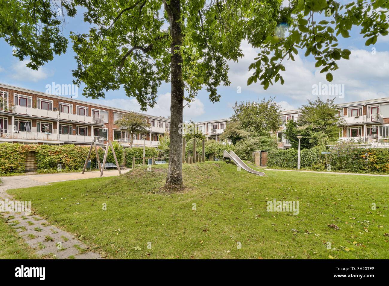 A vibrant community park featuring a playground, lush green grass, and ...