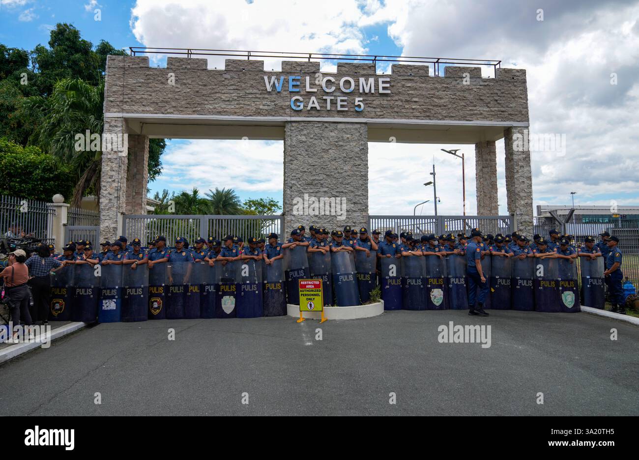 Police guard the gates of Villamor air base where former Philippine ...