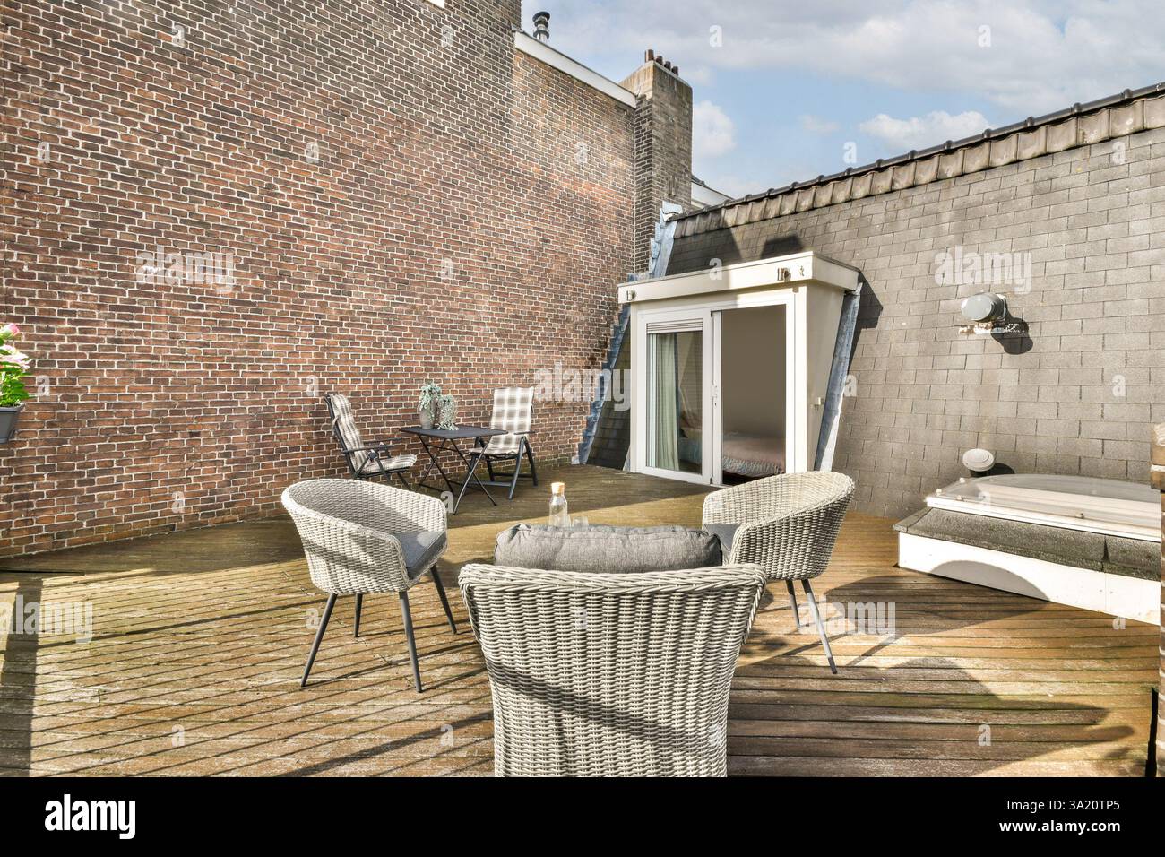 A stylish outdoor patio featuring modern furniture, wooden decking, and ...