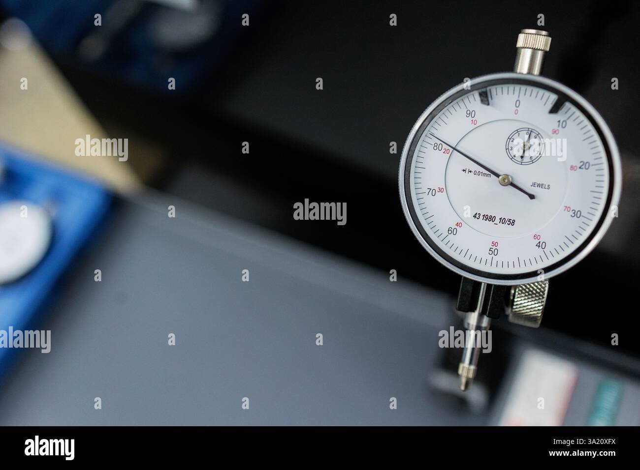 This intricate measuring tool rests on a workbench, reflecting the ...