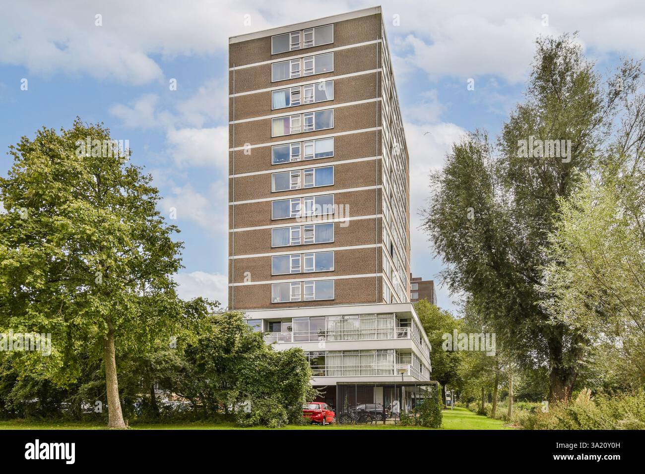 A contemporary multi-story residential building stands prominently ...