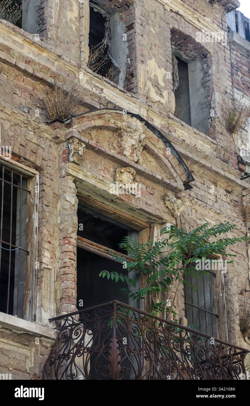 An aged building in Bucharest reveals peeling paint and deteriorating ...