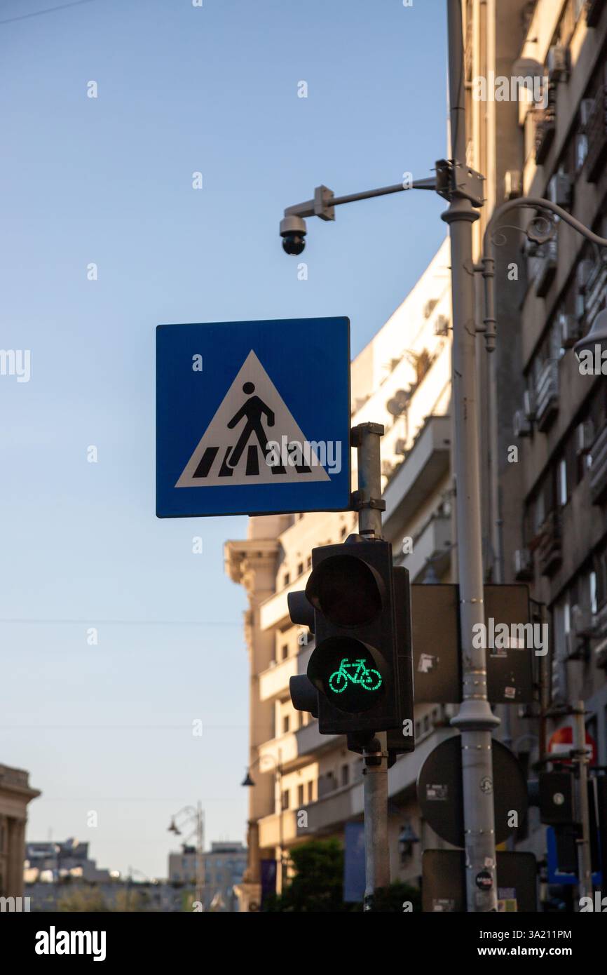 Traffic signals guide pedestrians and cyclists in a busy urban area ...