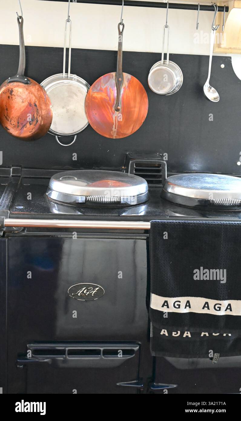 Aga stove with copper and steel cooking pots in kitchen interior ...