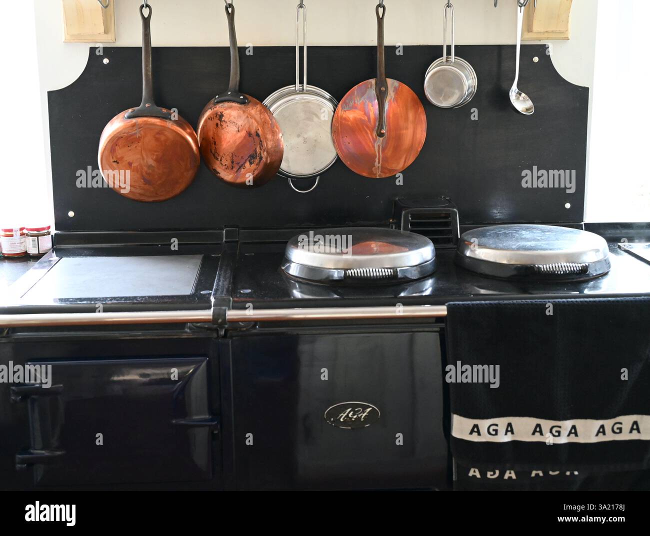 Aga stove with copper and steel cooking pots in kitchen interior Stock ...