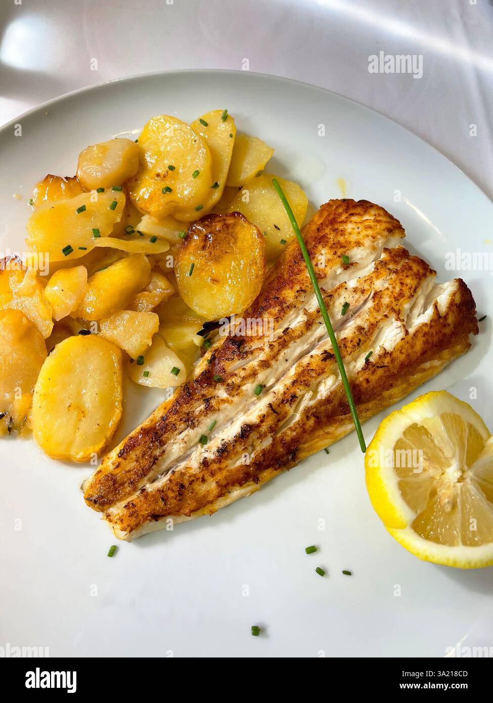 Grilled hake fillet with potatoes. Spain Stock Photo - Alamy