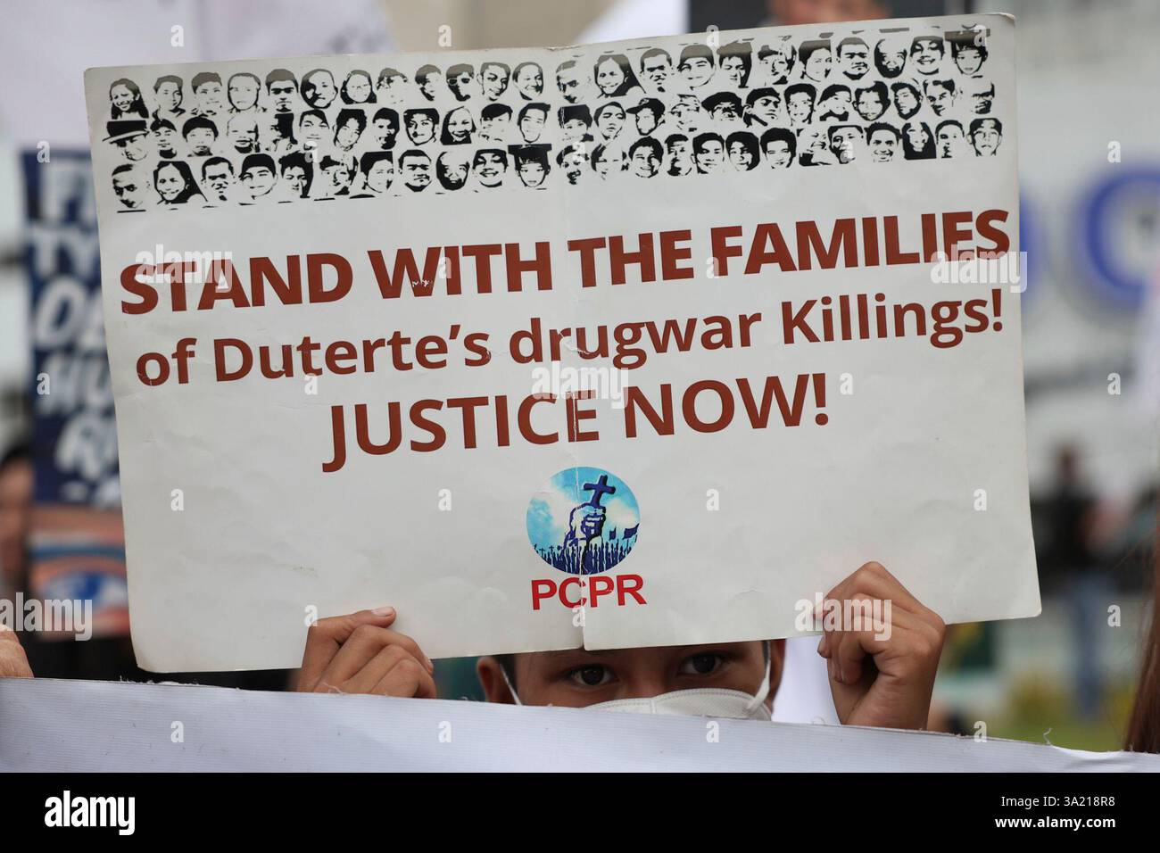 A person holds a sign against former Philippine President Rodrigo ...