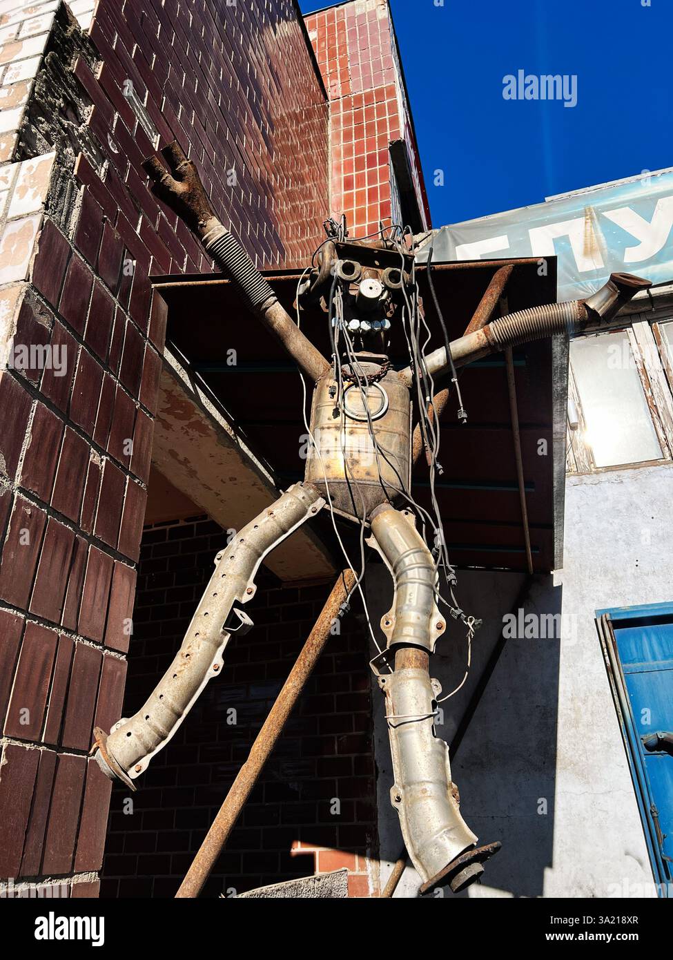 Artistic metal sculpture depicting a human form, built with recycled ...