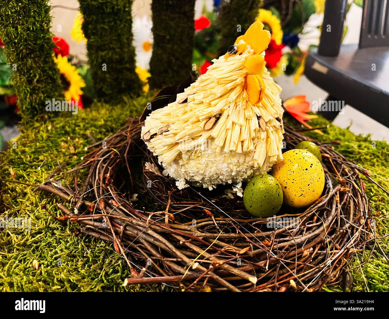 Handcrafted hen statue with vibrant details resting on eggs in rustic ...