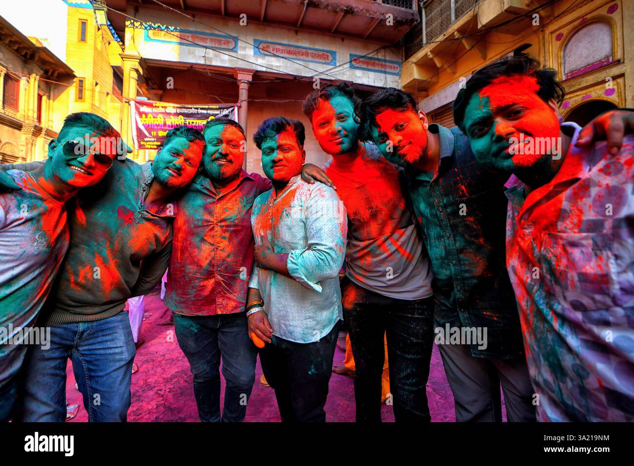 Devotees with colour all over pose for a photo during Holi Festival ...