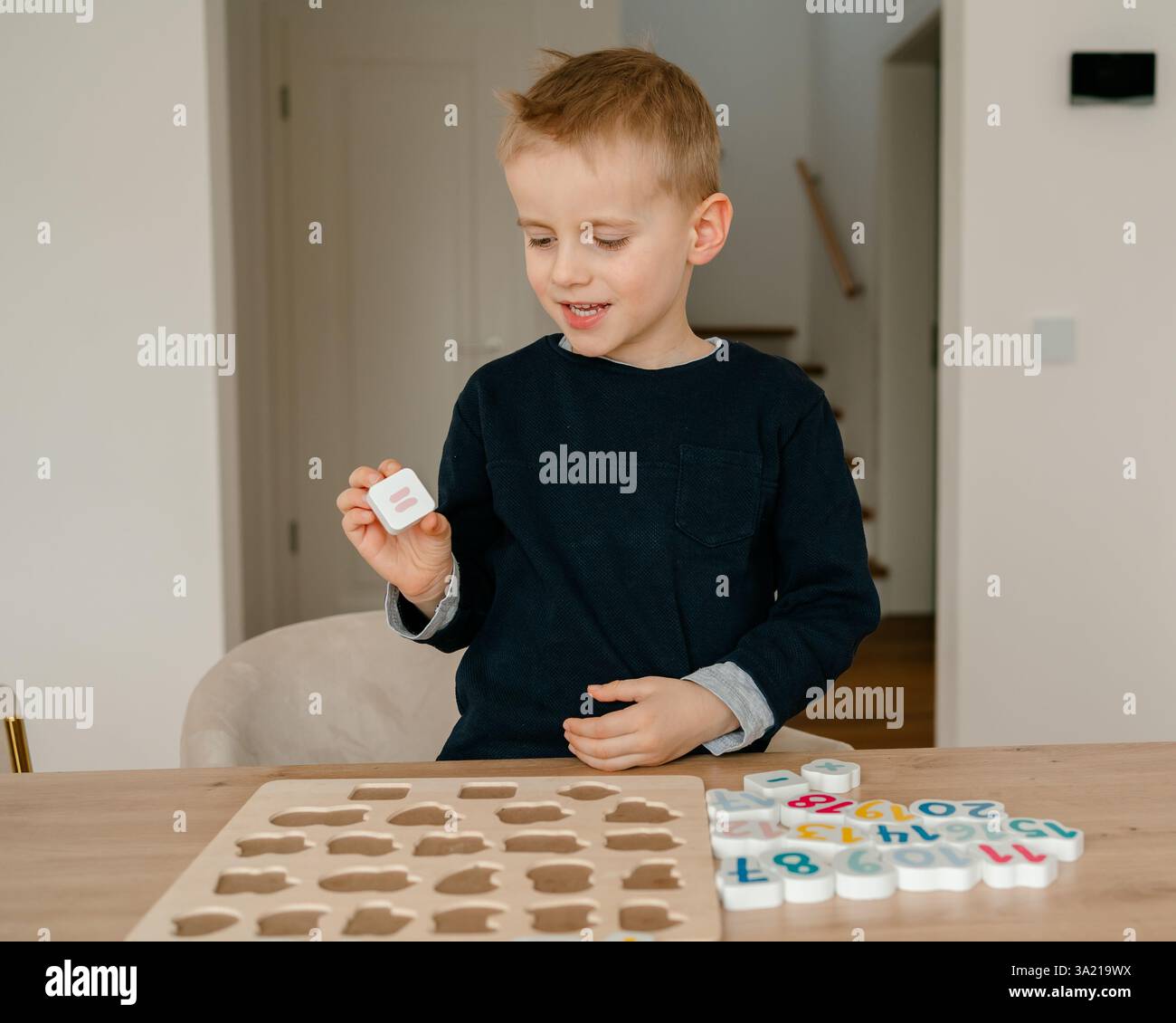 boy learns to count by laying out numbers from 1 to 20 on the board ...
