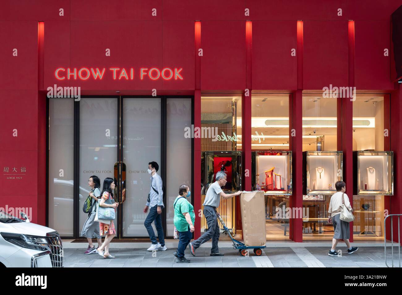 Pedestrians walk past the jewelry Chow Tai Fook chain store in Hong ...