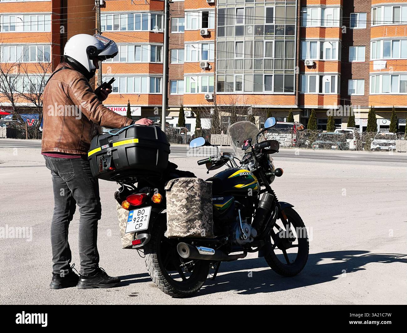 Kyiv, Ukraine - March 10, 2025: Motorcyclist in helmet and jacket ...