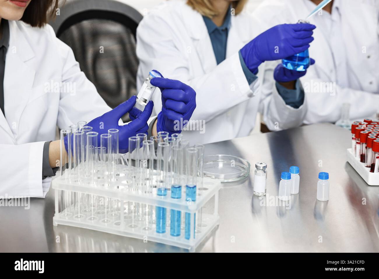 Scientists working with samples at table in laboratory, closeup Stock ...