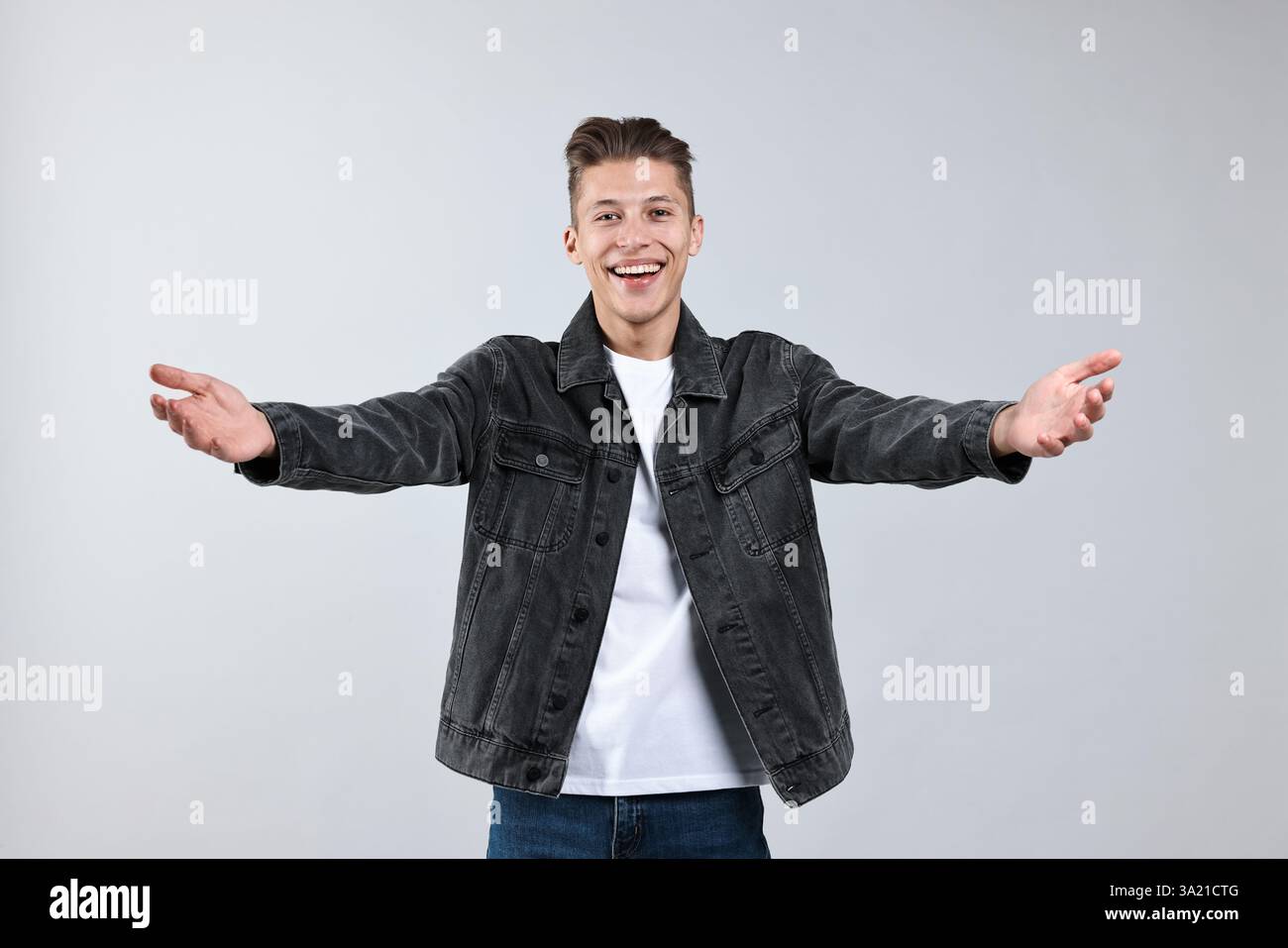 Happy man welcoming friends hi-res stock photography and images - Alamy