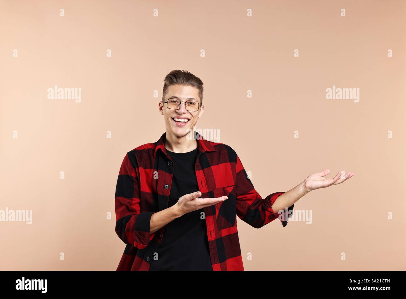 Happy man welcoming friends or guests on beige background Stock Photo ...