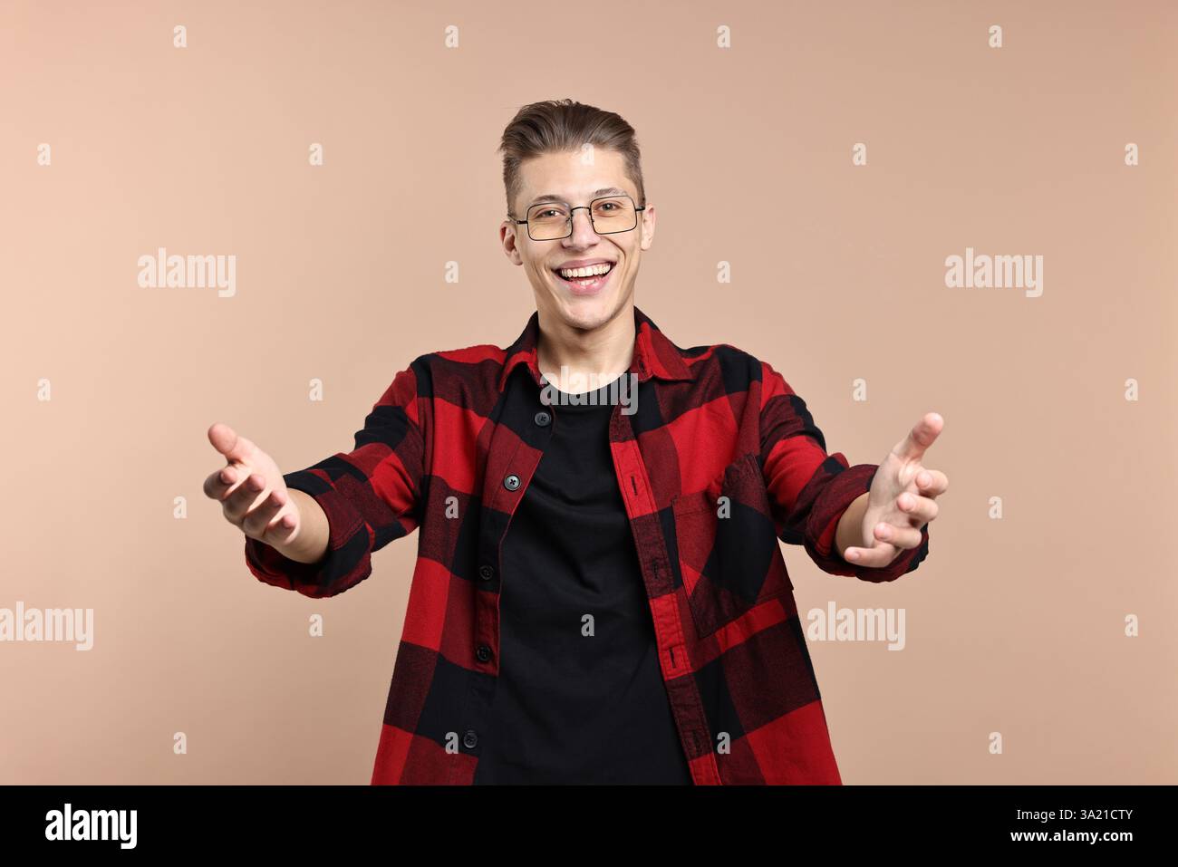 Handsome young man welcoming hi-res stock photography and images - Alamy
