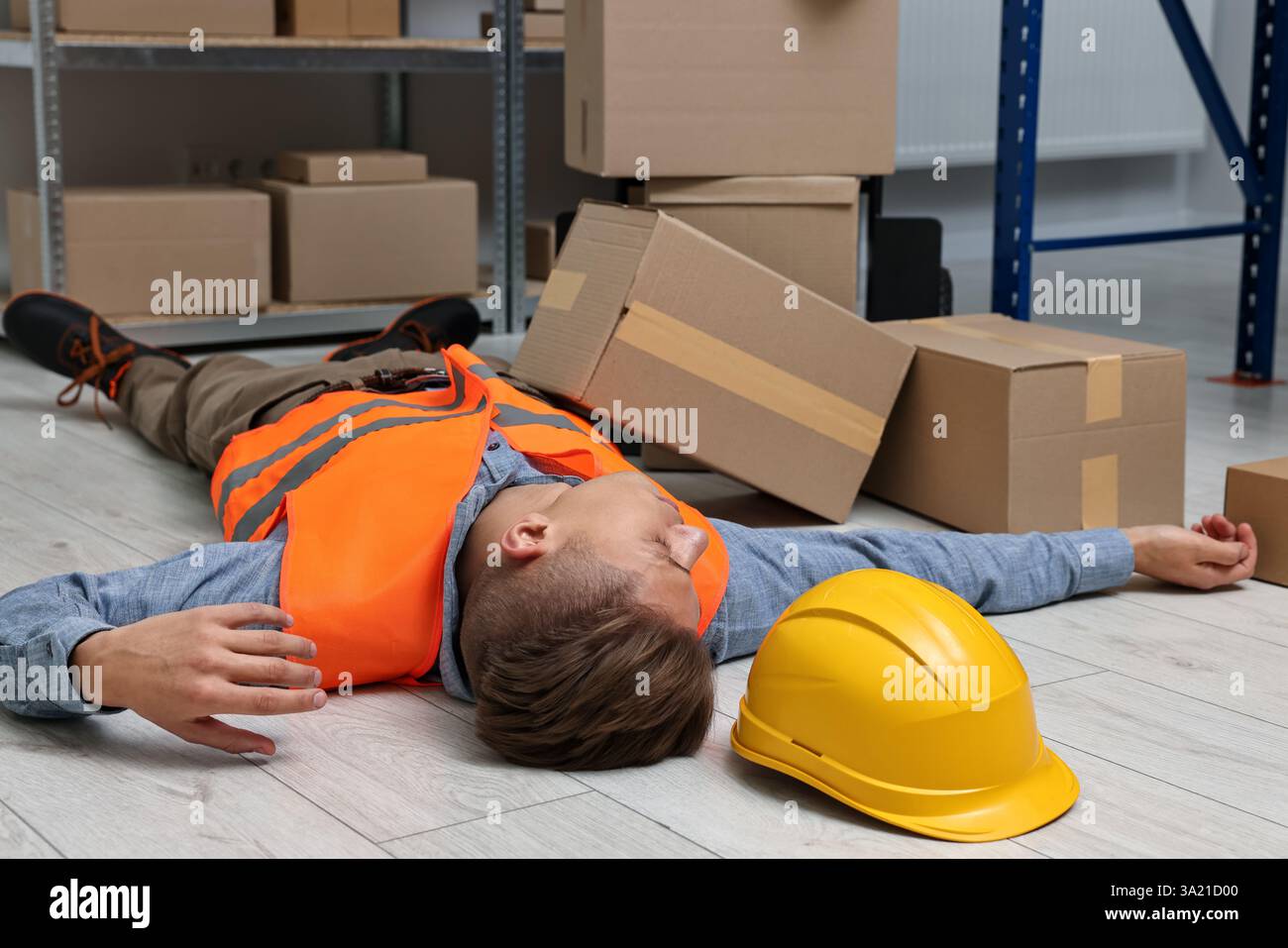 Accident at work. Unconscious man lying on floor in warehouse Stock ...