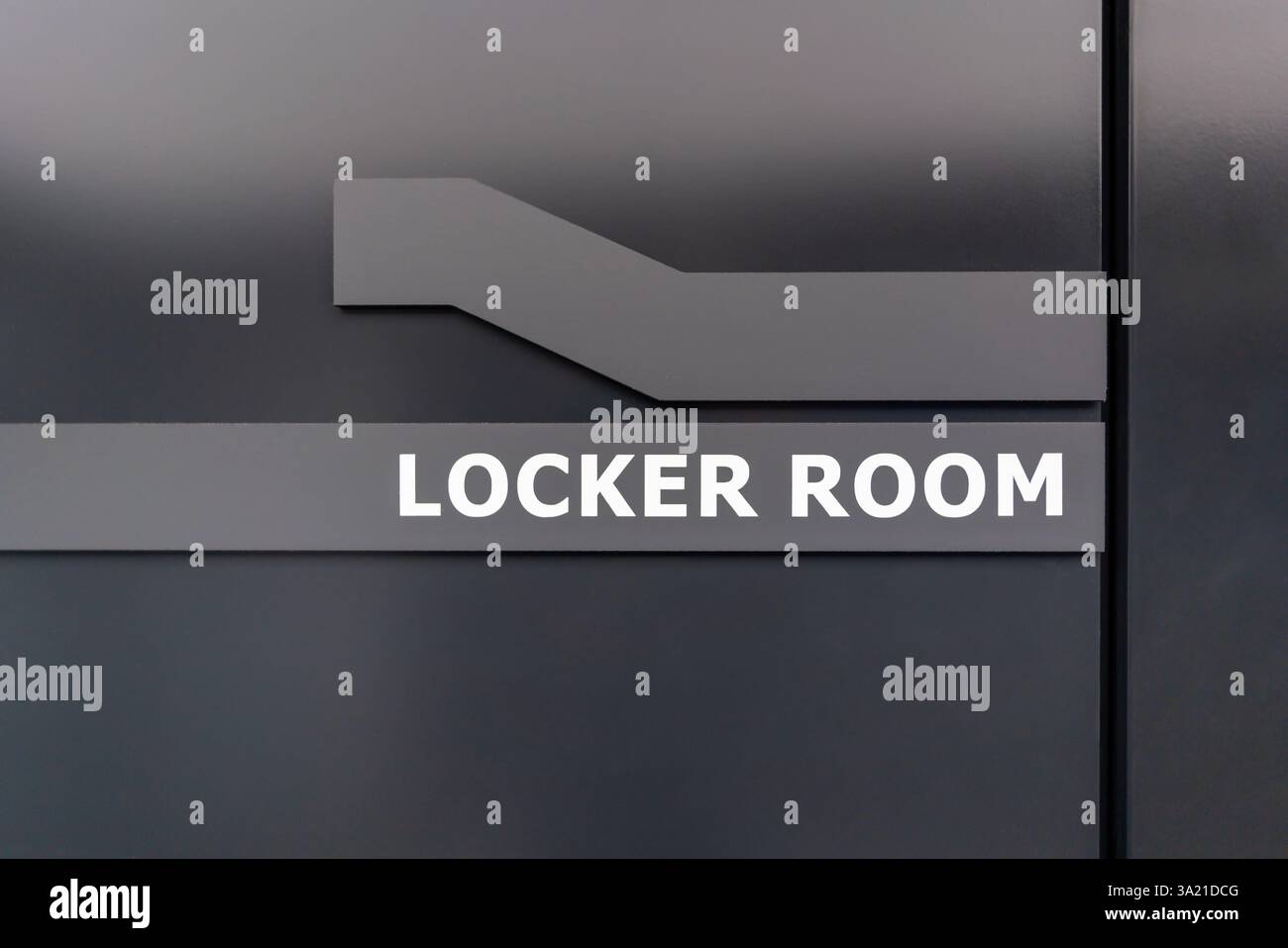 Modern locker room sign on a dark door in a sports or fitness facility ...