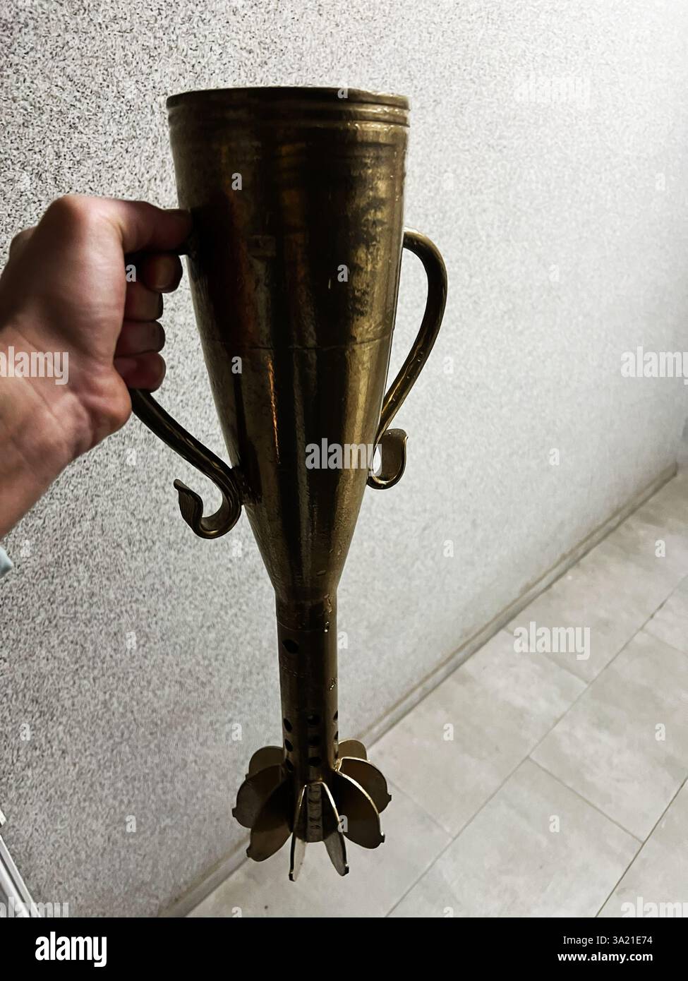 A golden decorative trophy created from a repurposed military artillery ...