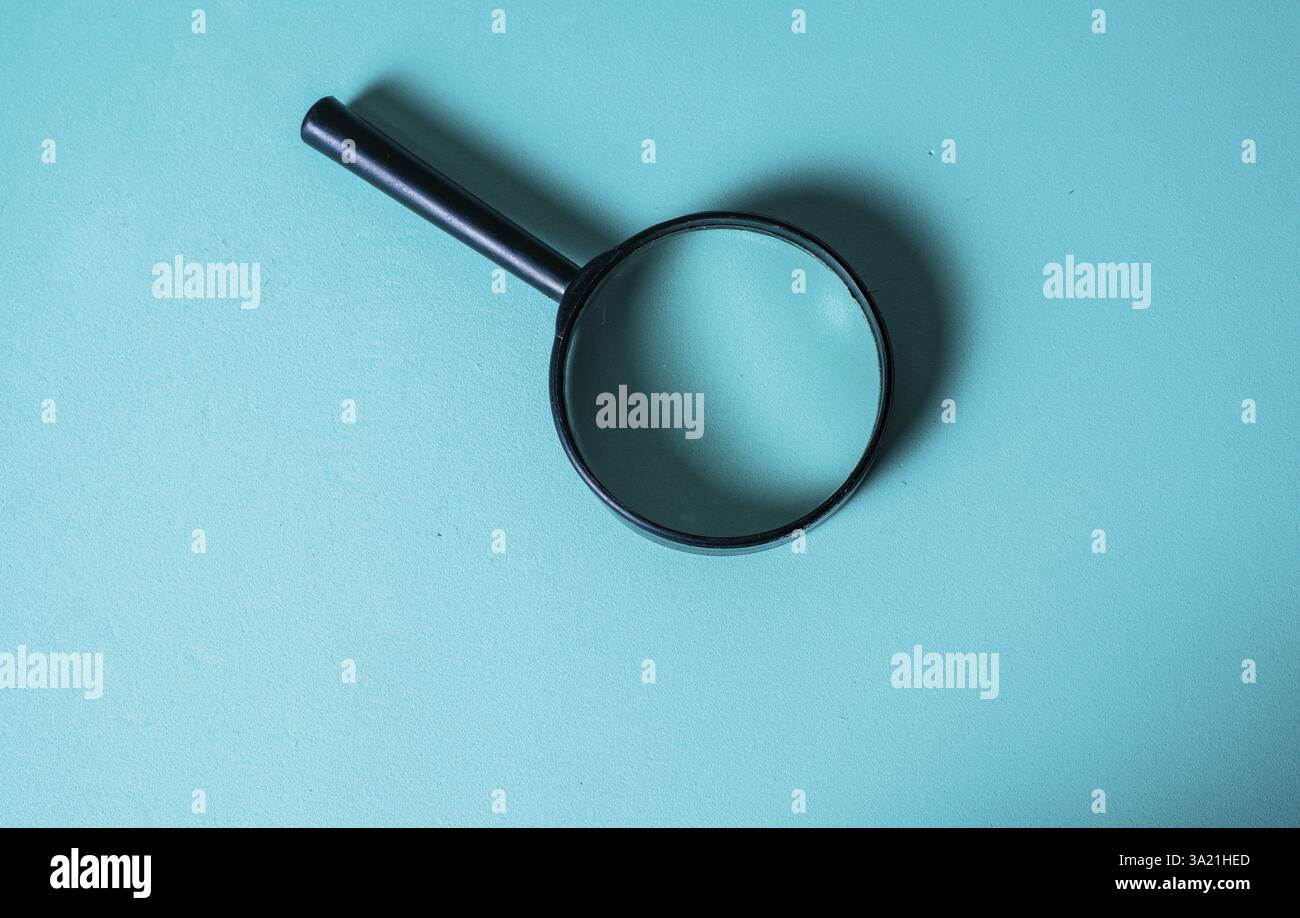Magnifying Glass on Teal Background for Investigation Concept. CloseUp ...