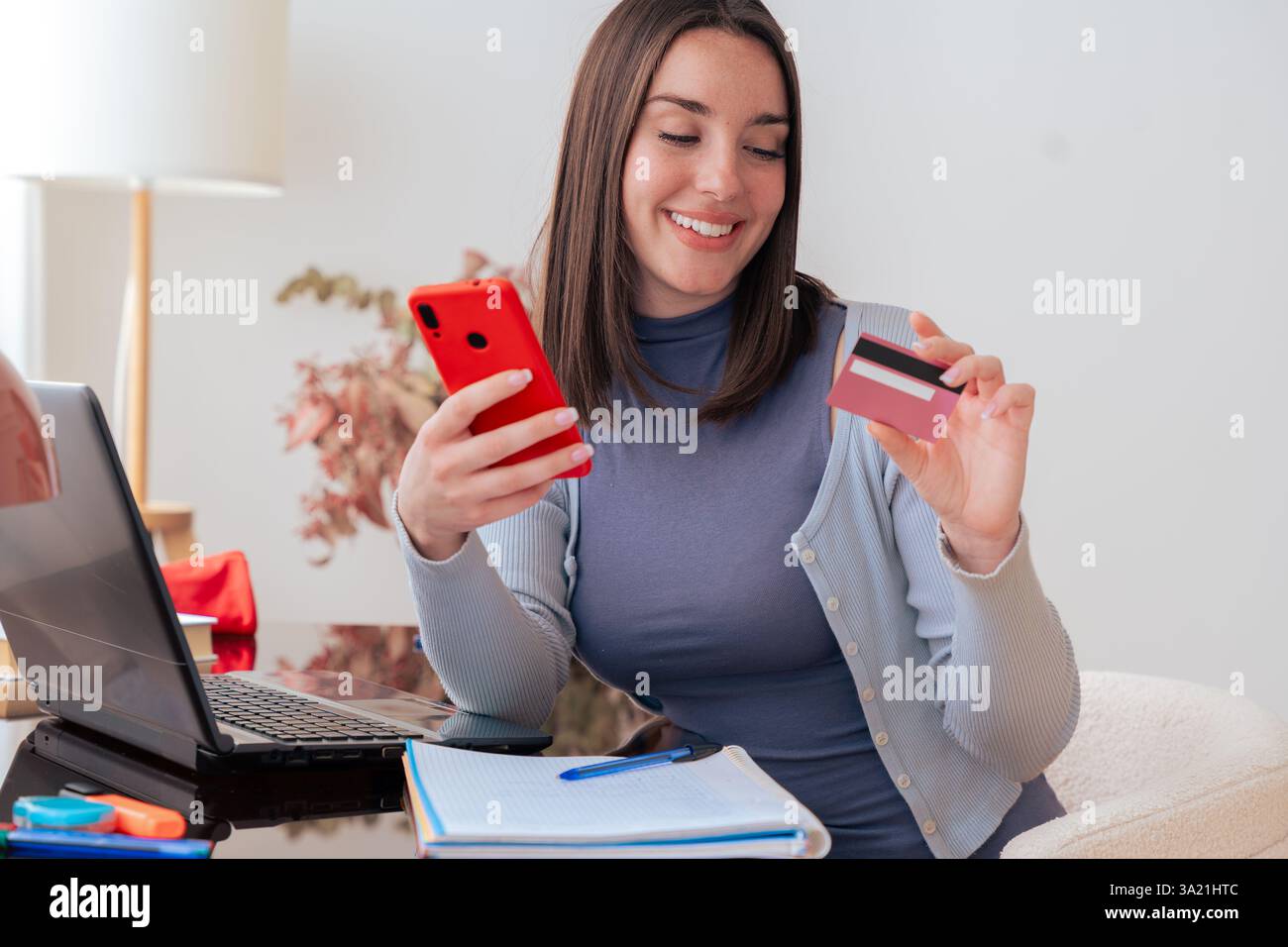 Caucasian student making online payment with credit card using ...