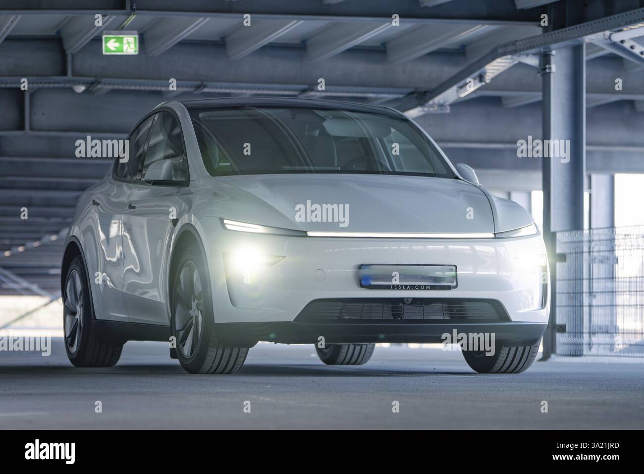 Front view of a futuristic-looking electric car with LED lights in a ...