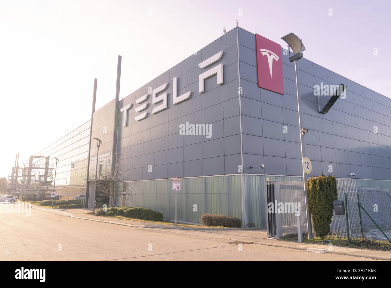 Tesla industrial plant with grey architecture in a sunny street scene ...