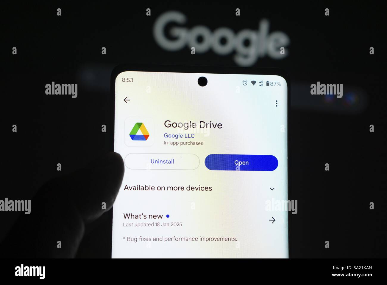 Google Drive on screen in front of website. Focus on phone display ...