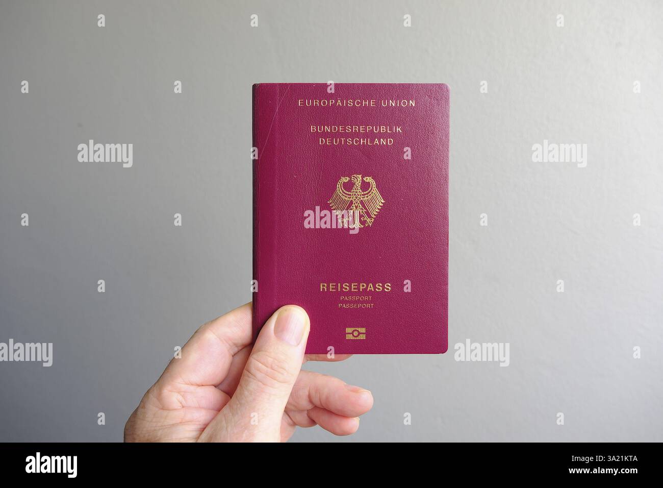 Hand holds a German passport Stock Photo - Alamy