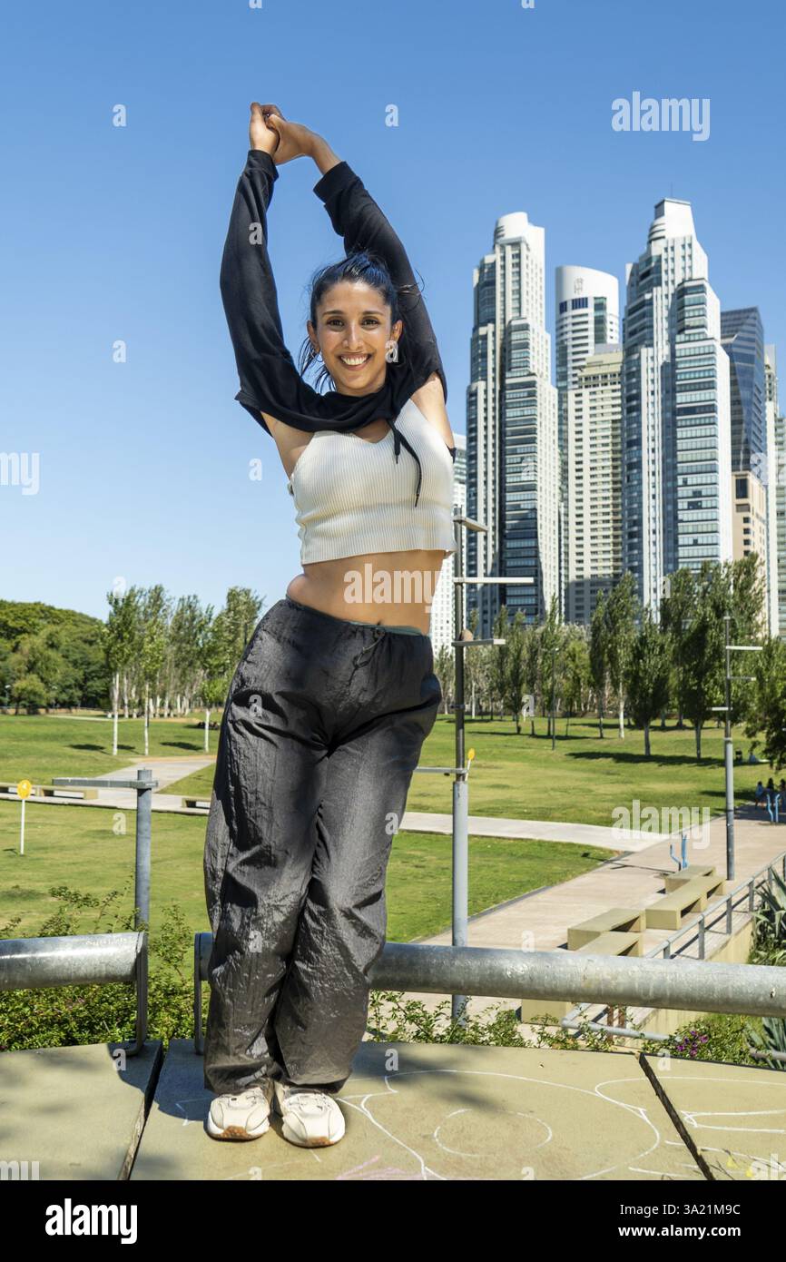 Dynamic dancer bringing energy to a green city space Stock Photo - Alamy