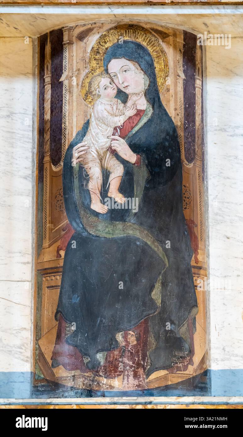 Medieval fresco portraiting Virgin Mary wearing blue and holding in her ...