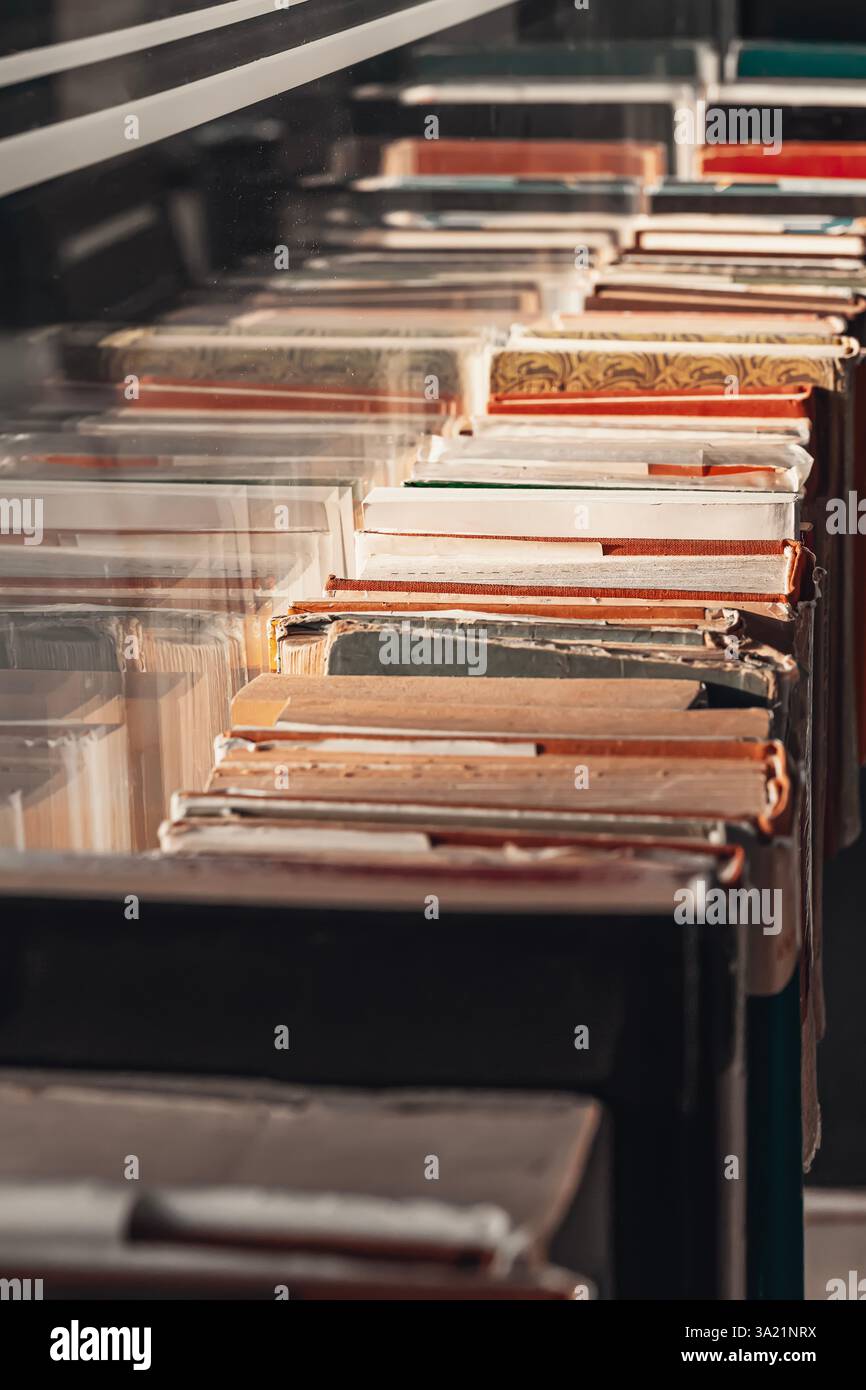 Pile of books and reflection. Old books stacked tightly on wooden ...