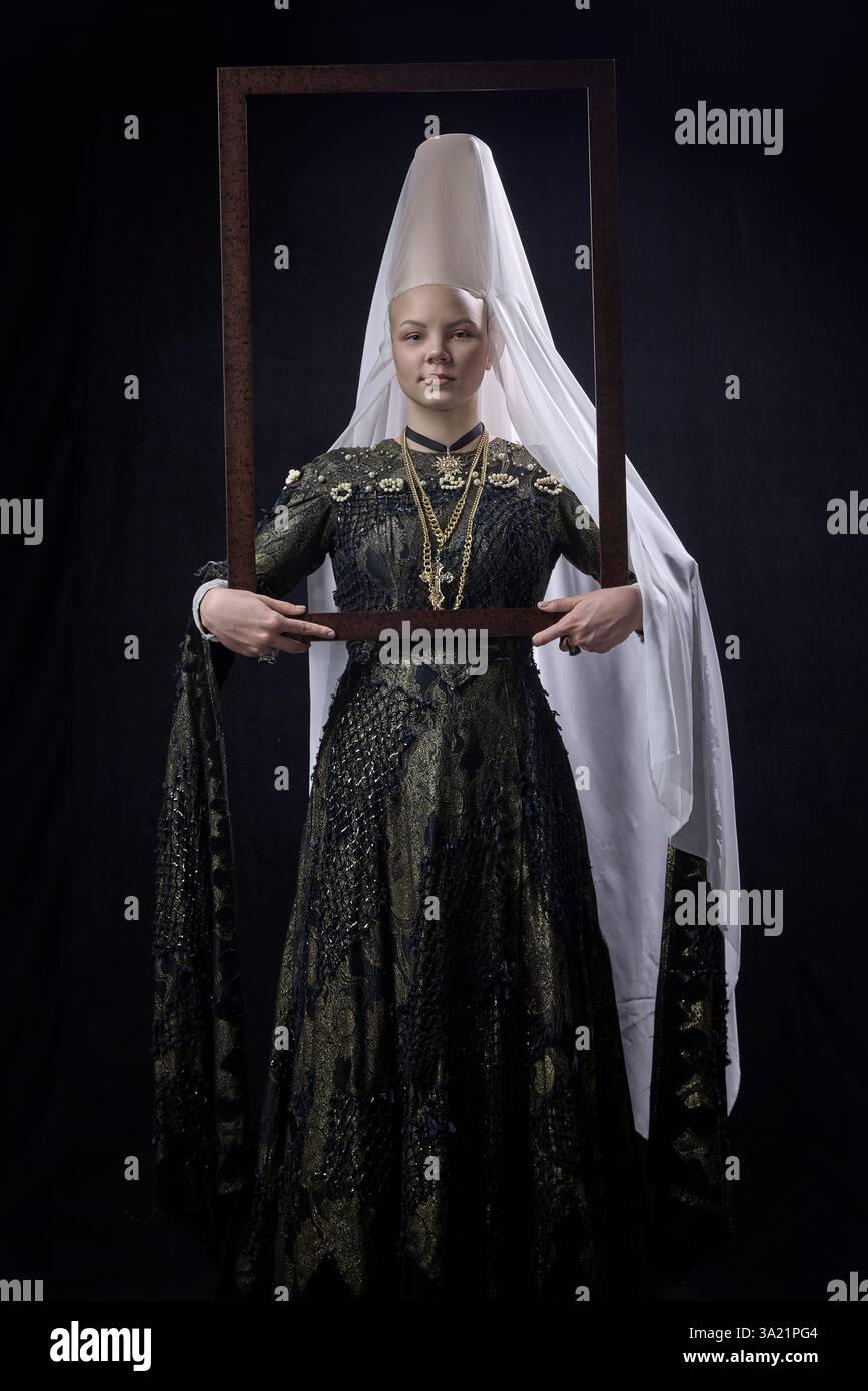 Portrait of noblewoman in renaissance attire holding wooden frame ...