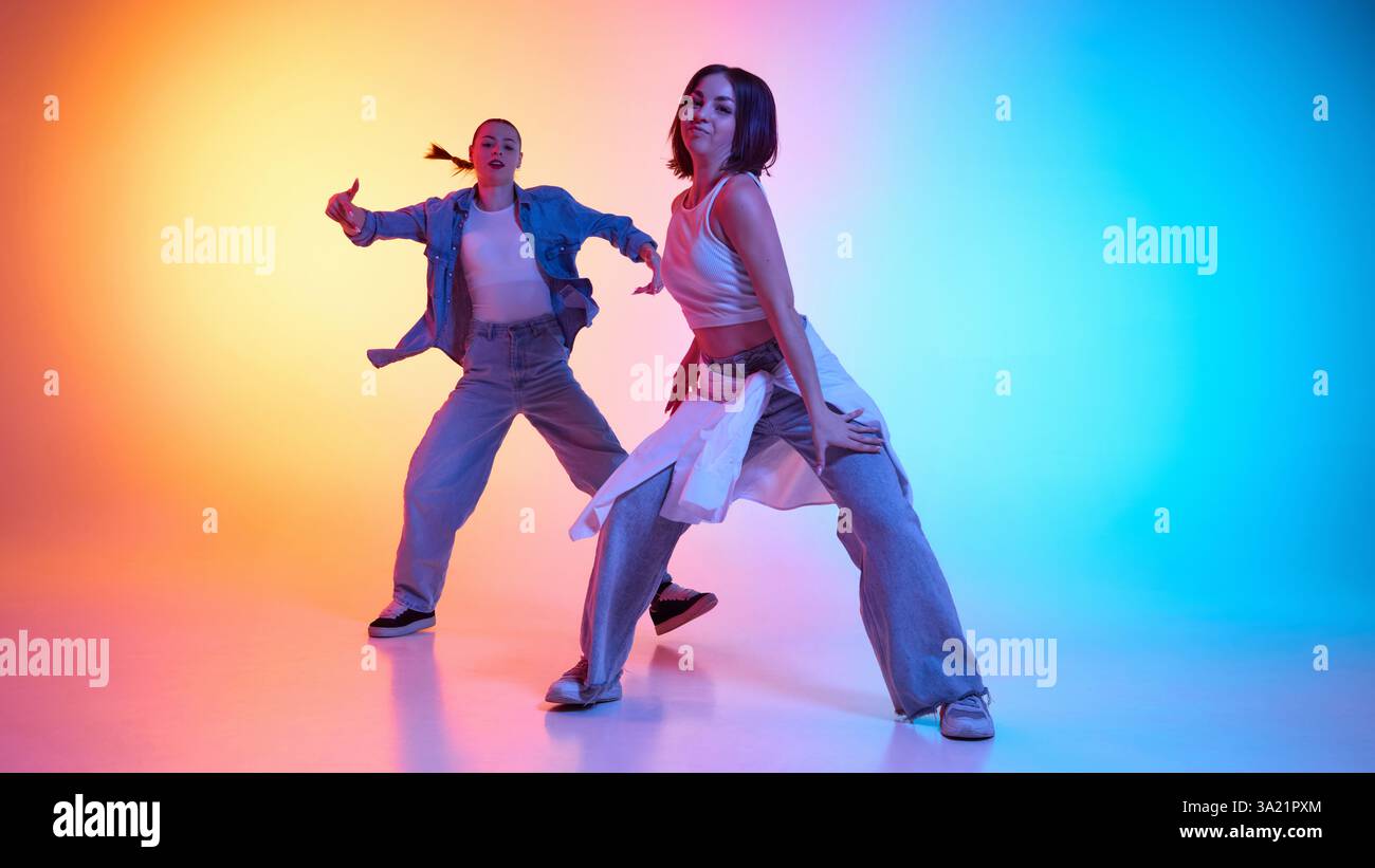 Dynamic hip hop energy. Two young women in casual attire dancing ...