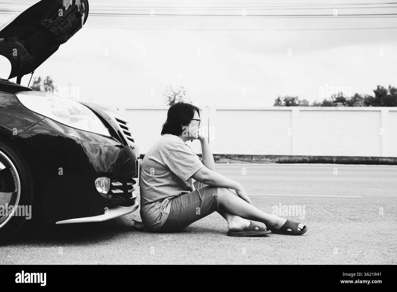 Asian woman 40s alone driver checking a car engine for fix and repair ...