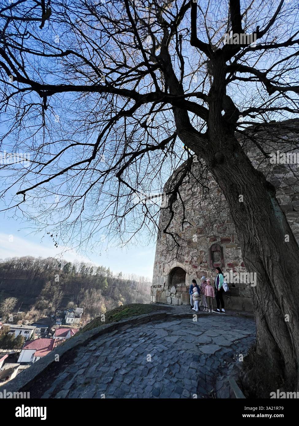 A family exploring a historic stone building surrounded by nature on a ...