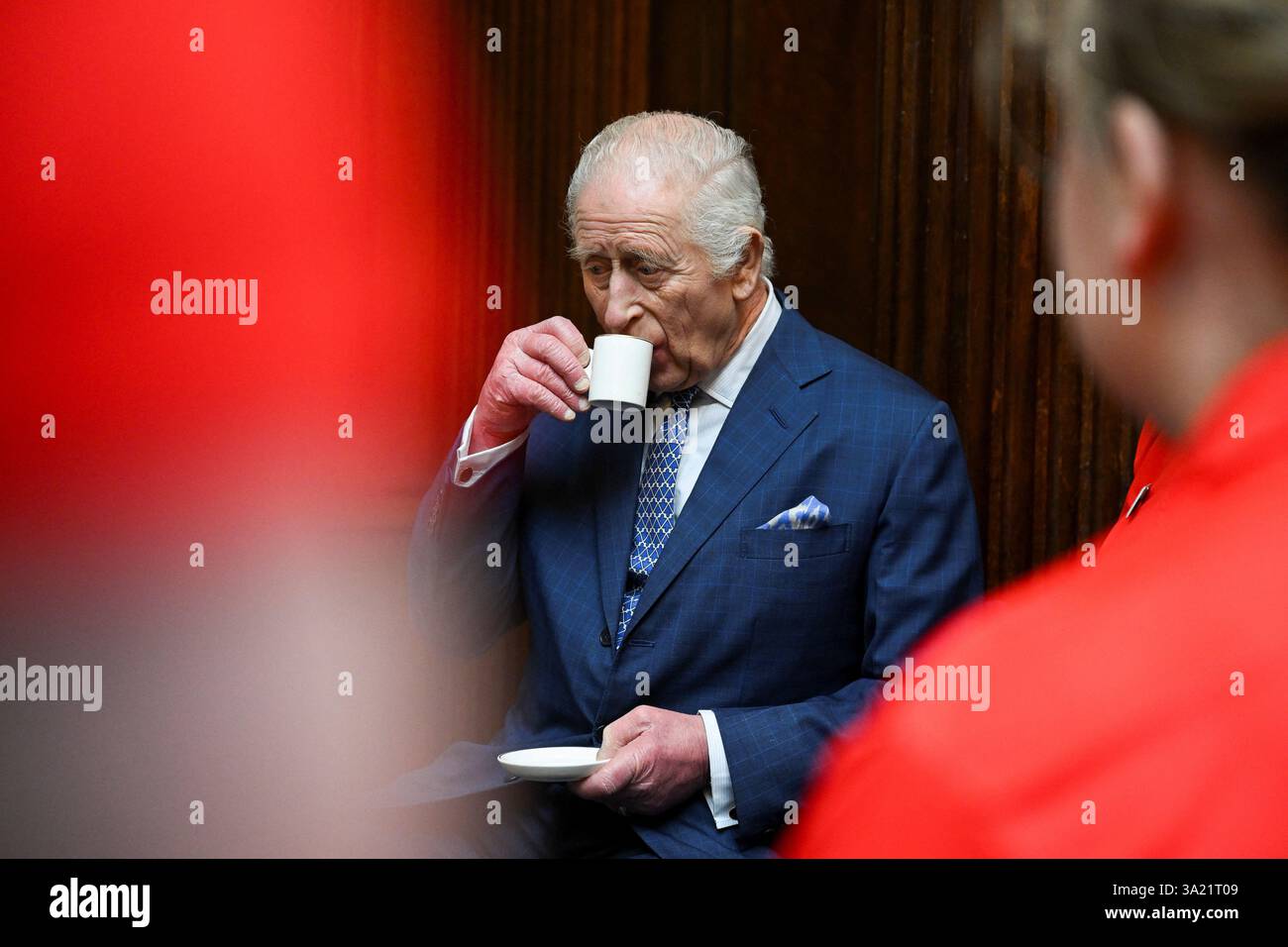 King Charles III drinks from a cup as he attends a celebration for the ...