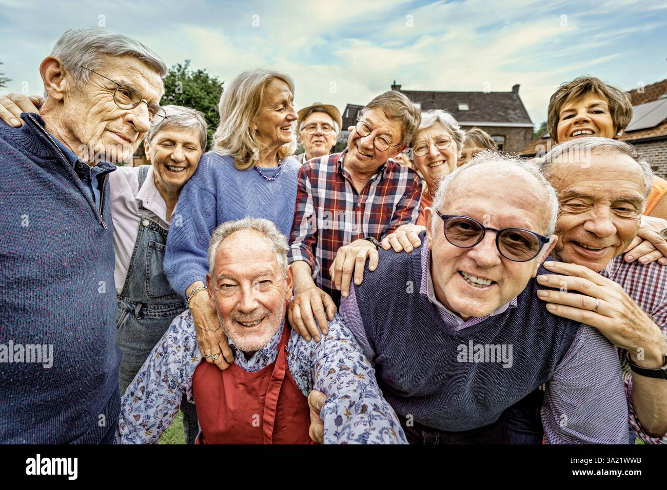 Group of happy seniors posing together at outdoor community gathering ...