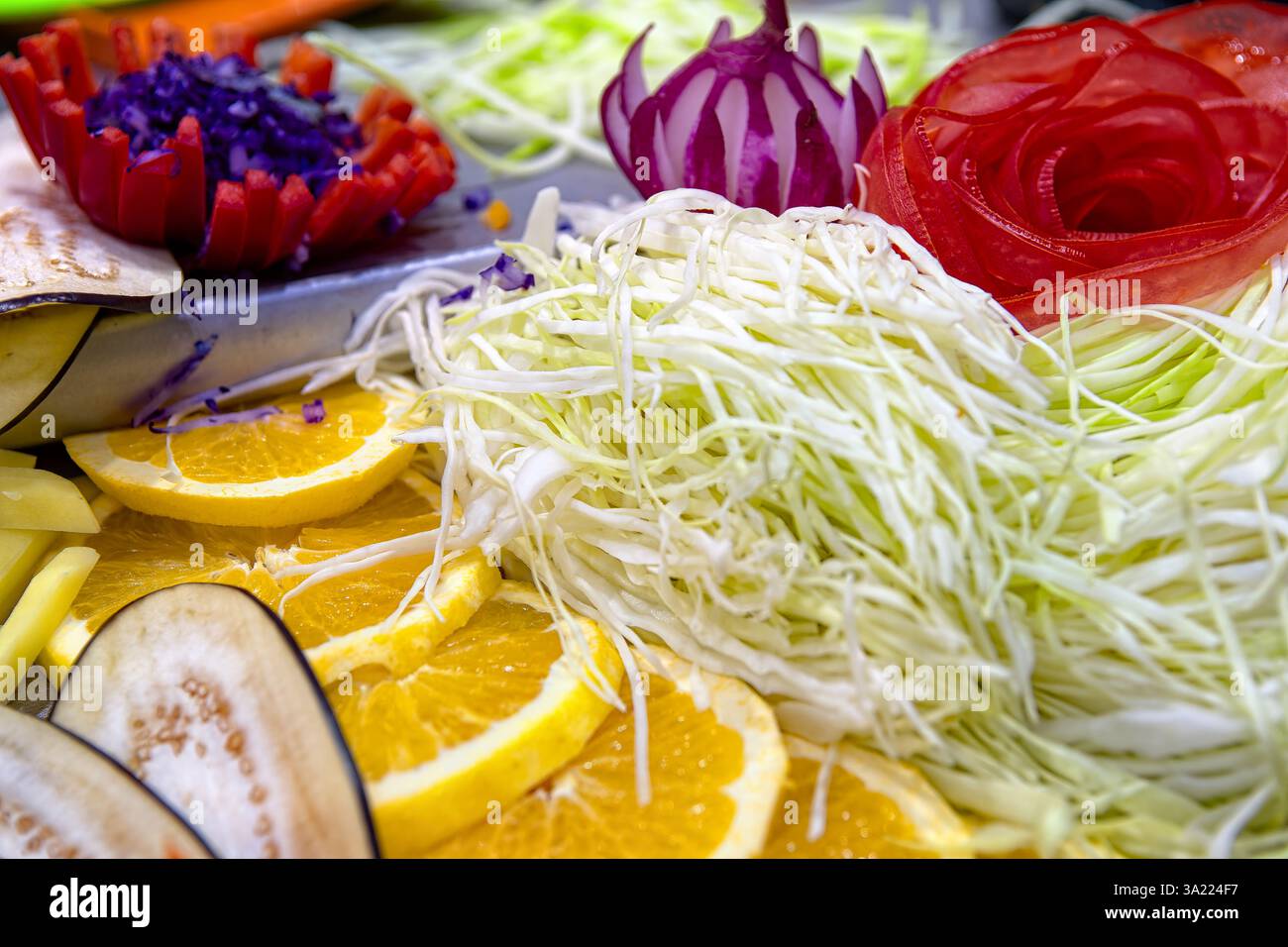 Various shredded grated chopped fresh vegetables and fruits as salad ...