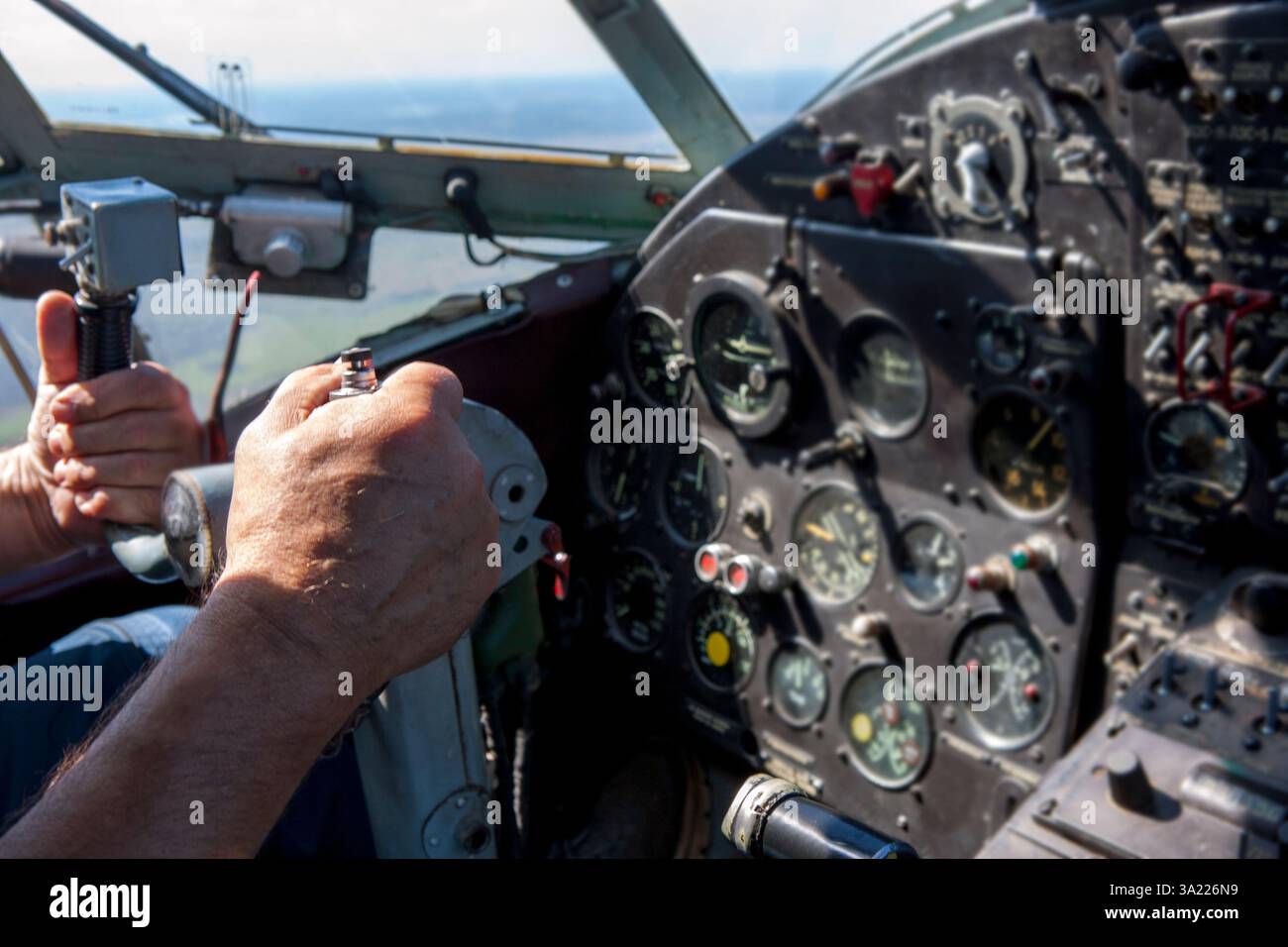 controls in a cockpit and hands of pilot on the steering wheel Stock ...