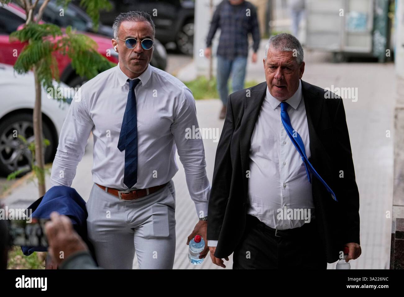 Physician Leopoldo Luque, left, arrives with lawyer Julio Rivas for a ...