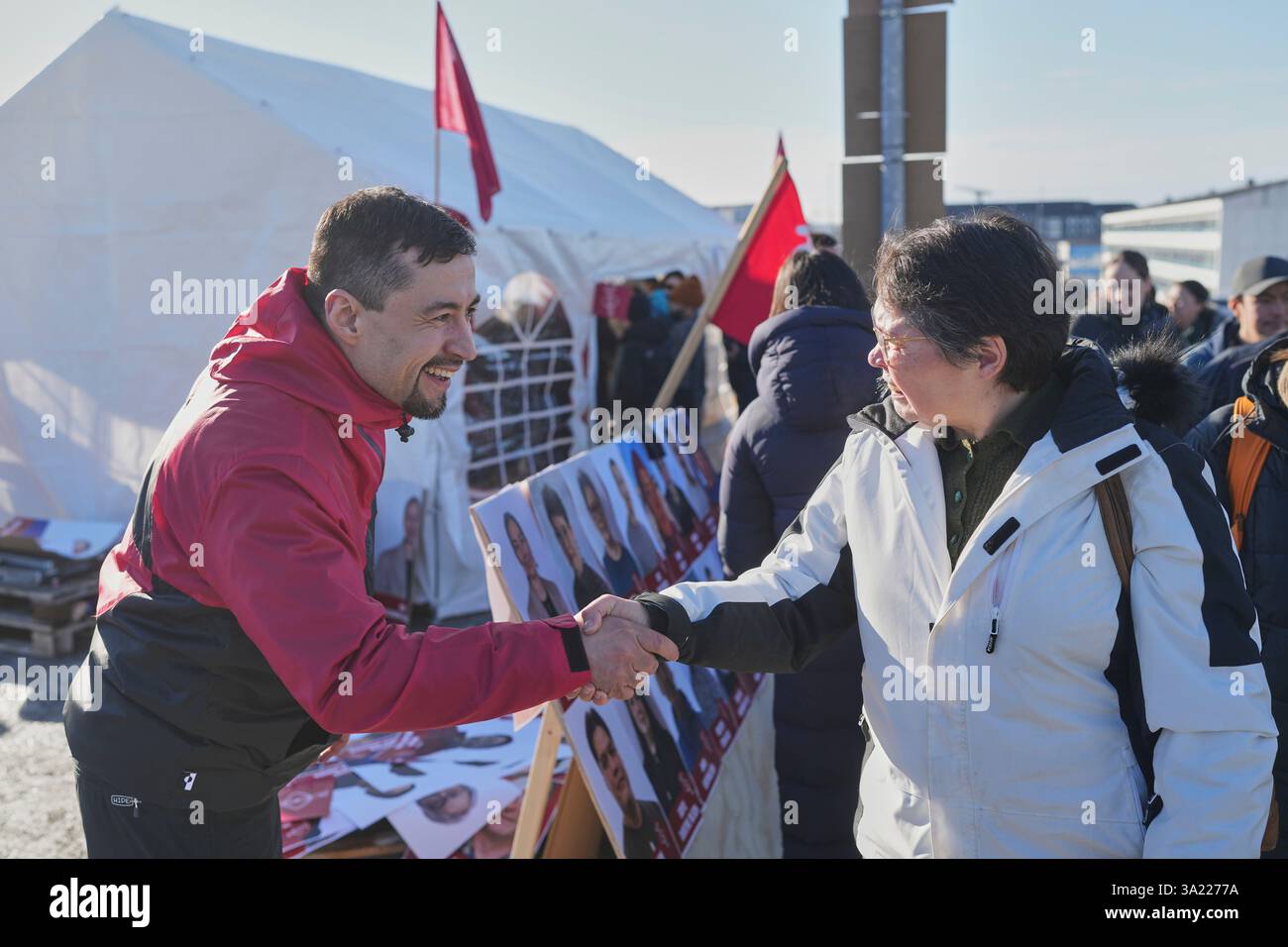 Greenland's Prime Minister Mute Bourup Egede, left, greets a voter ...