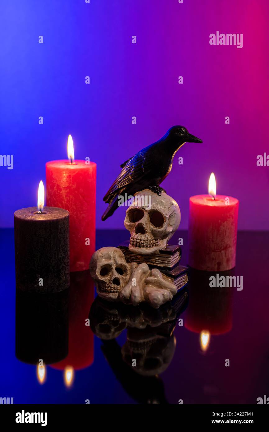 Crow figure sitting on the skulls and bones. Candles burning around ...