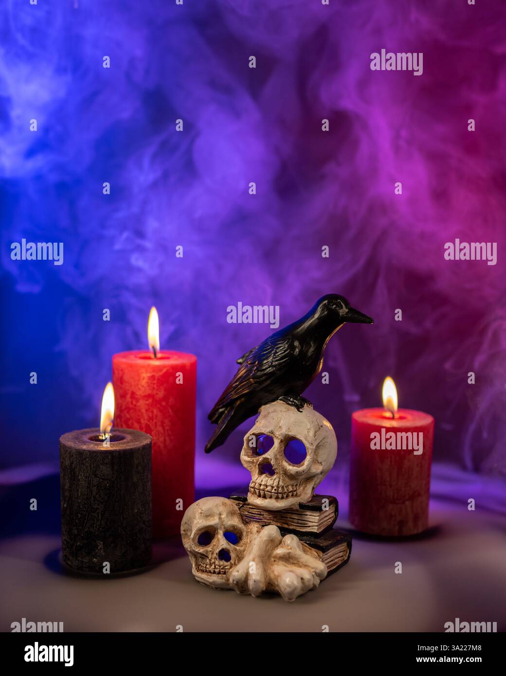Crow figure sitting on the skulls and bones. Candles burning around ...
