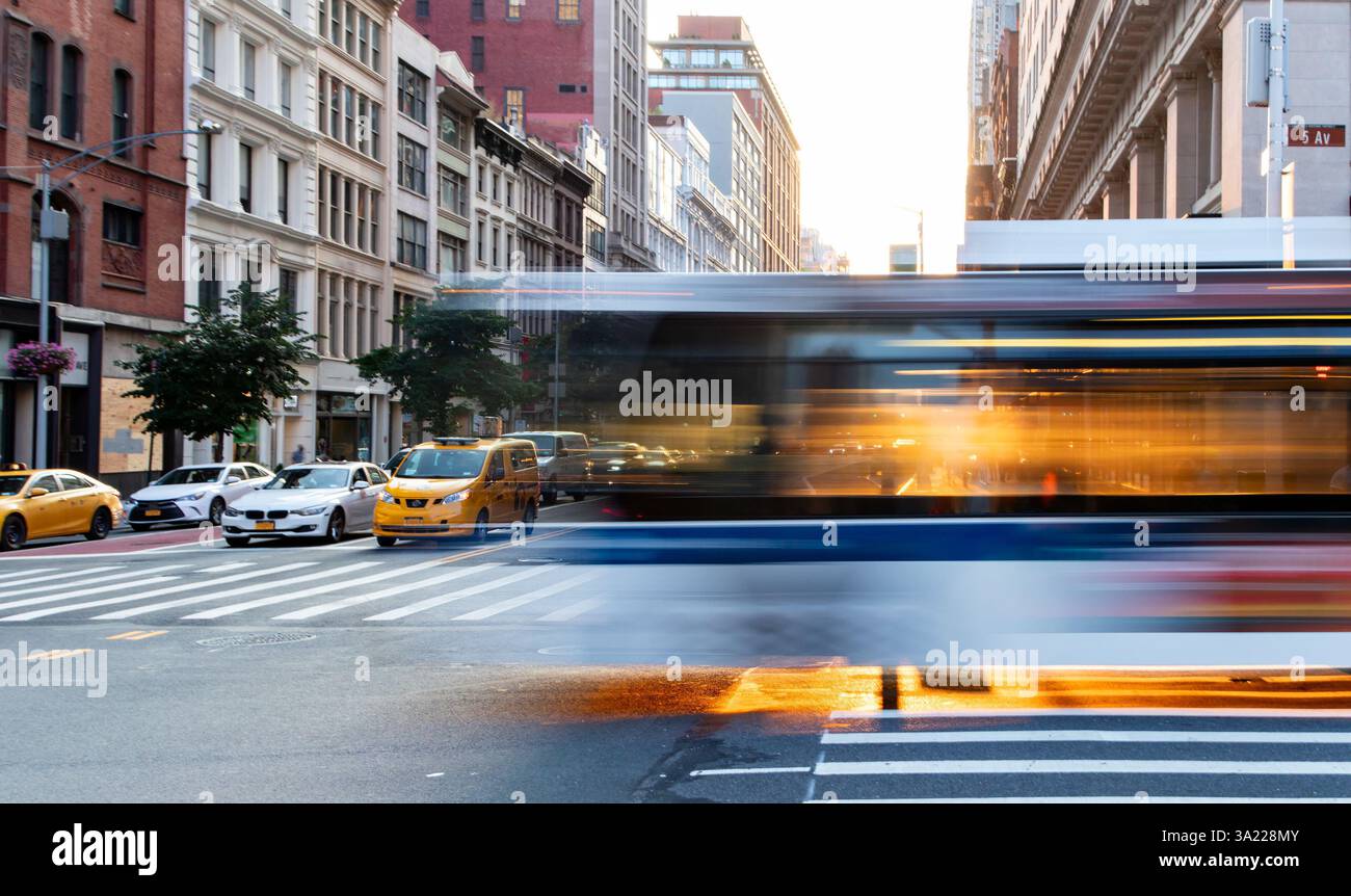 City bus driving through the busy intersection of 5th Avenue and 23rd ...